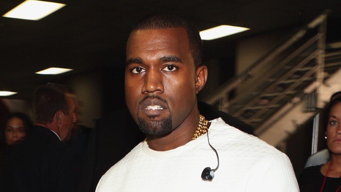 Kanye West attends Balenciaga fashion show wearing full face covering ...